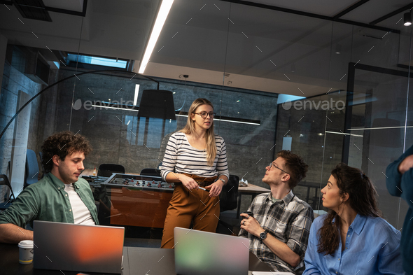 Programmers work alongside their colleagues in an office Stock Photo by milanzeremski